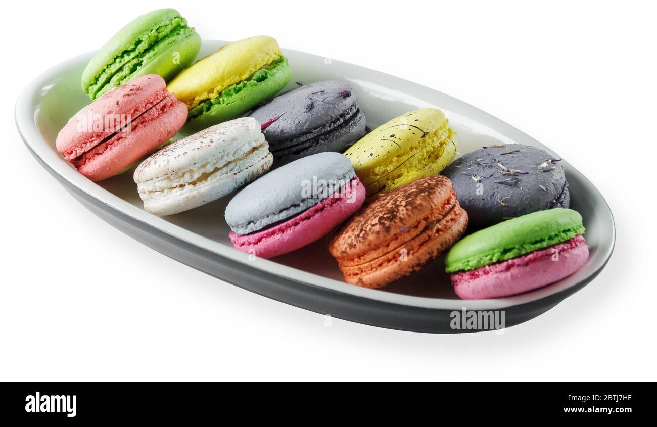 A plate of traditional french macaroons on a white background isolated ...