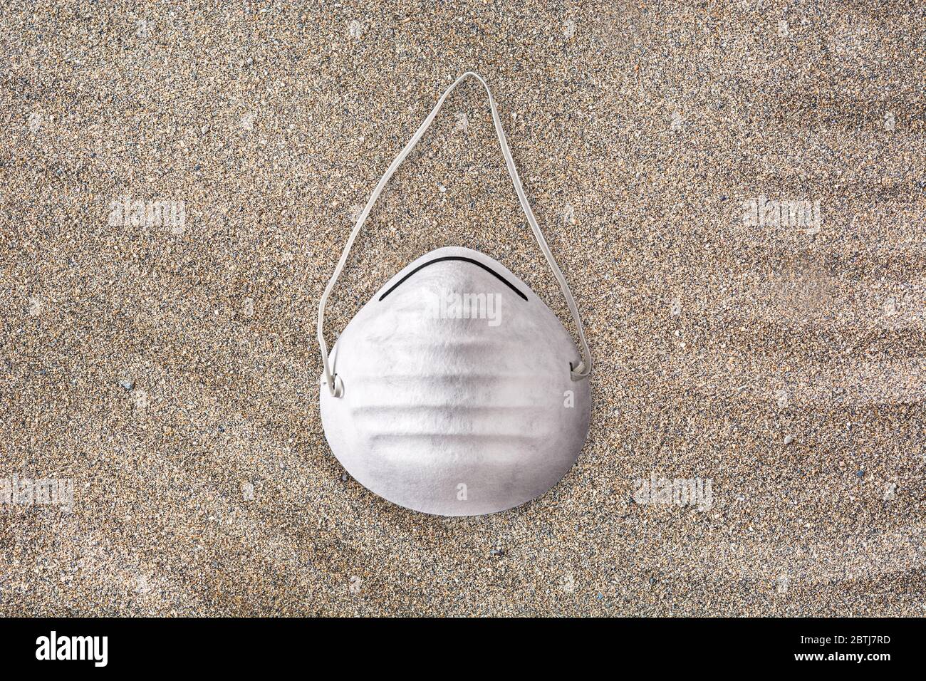 Medical protective mask on sand background Stock Photo - Alamy