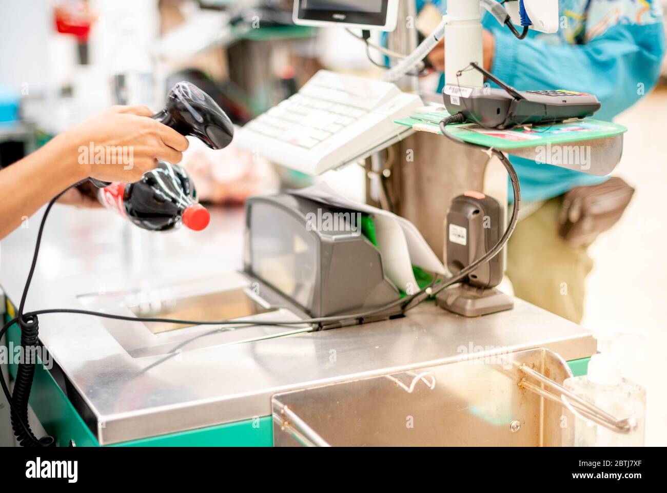 Close up of female hand scanning goods with barcode reader for pay at ...