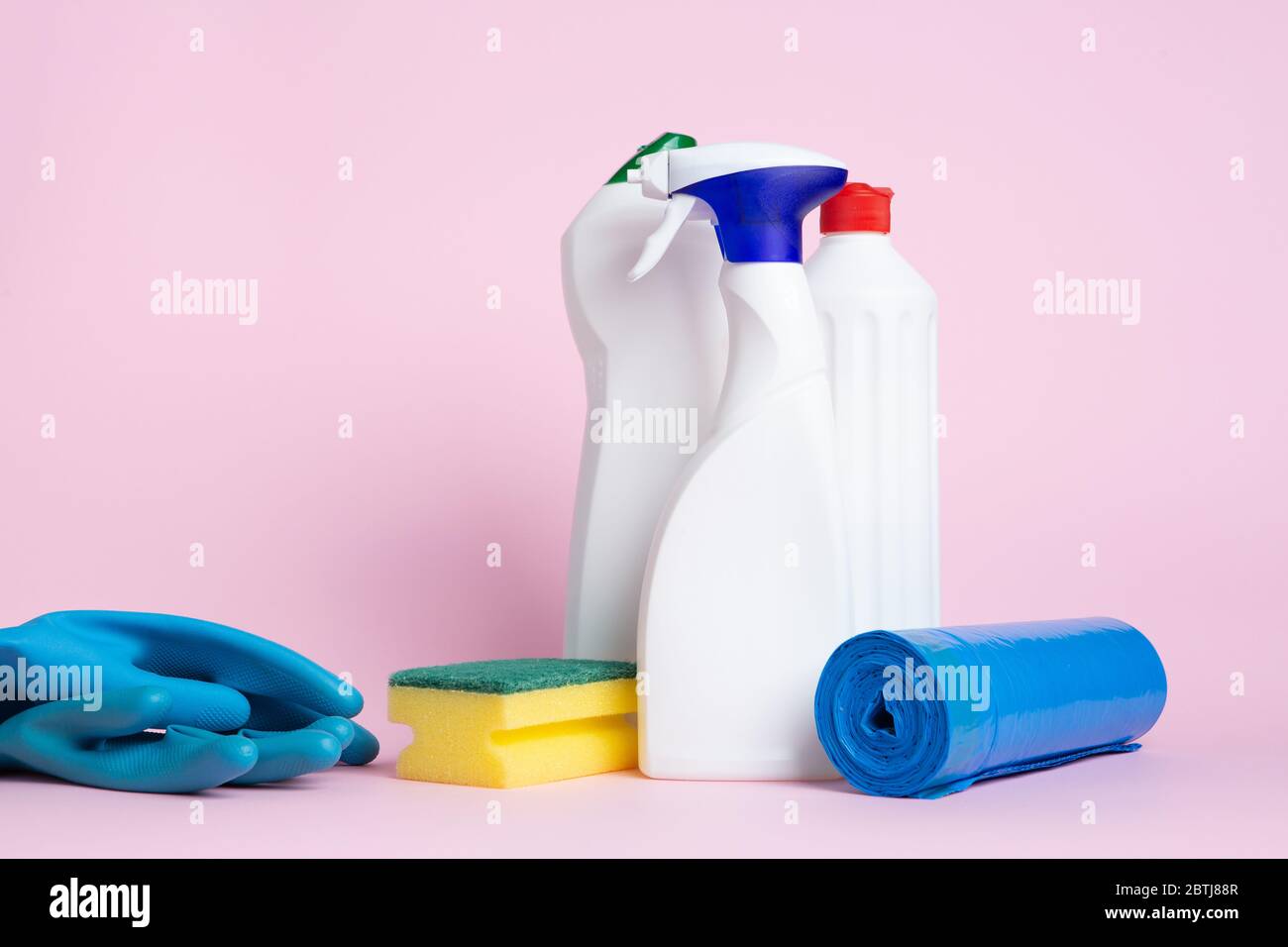 Three cans of cleaning spray with a scouring pad, globes and garbage ...