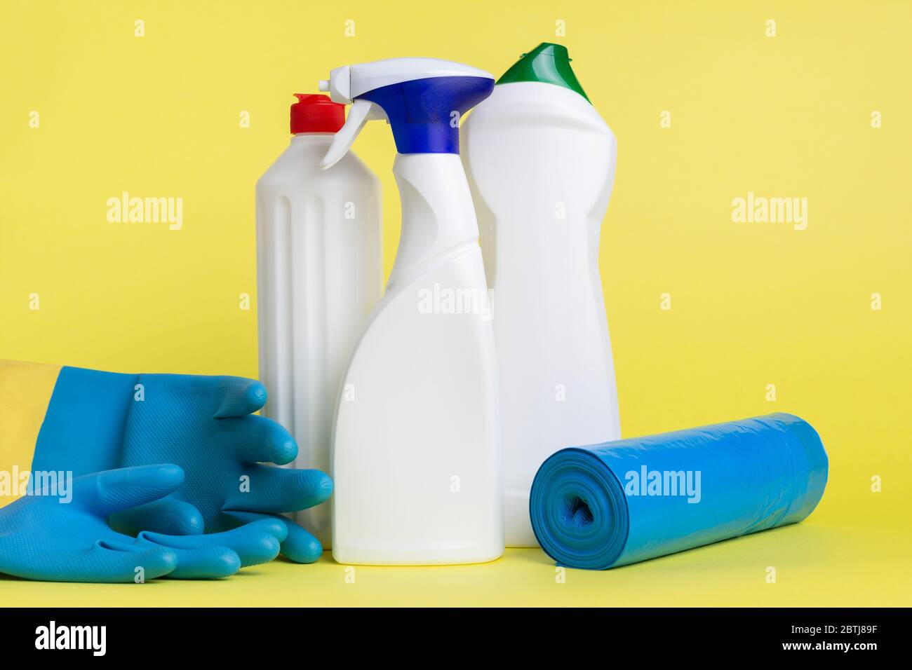 Three cans of cleaning spray with a scouring pad, globes and garbage ...