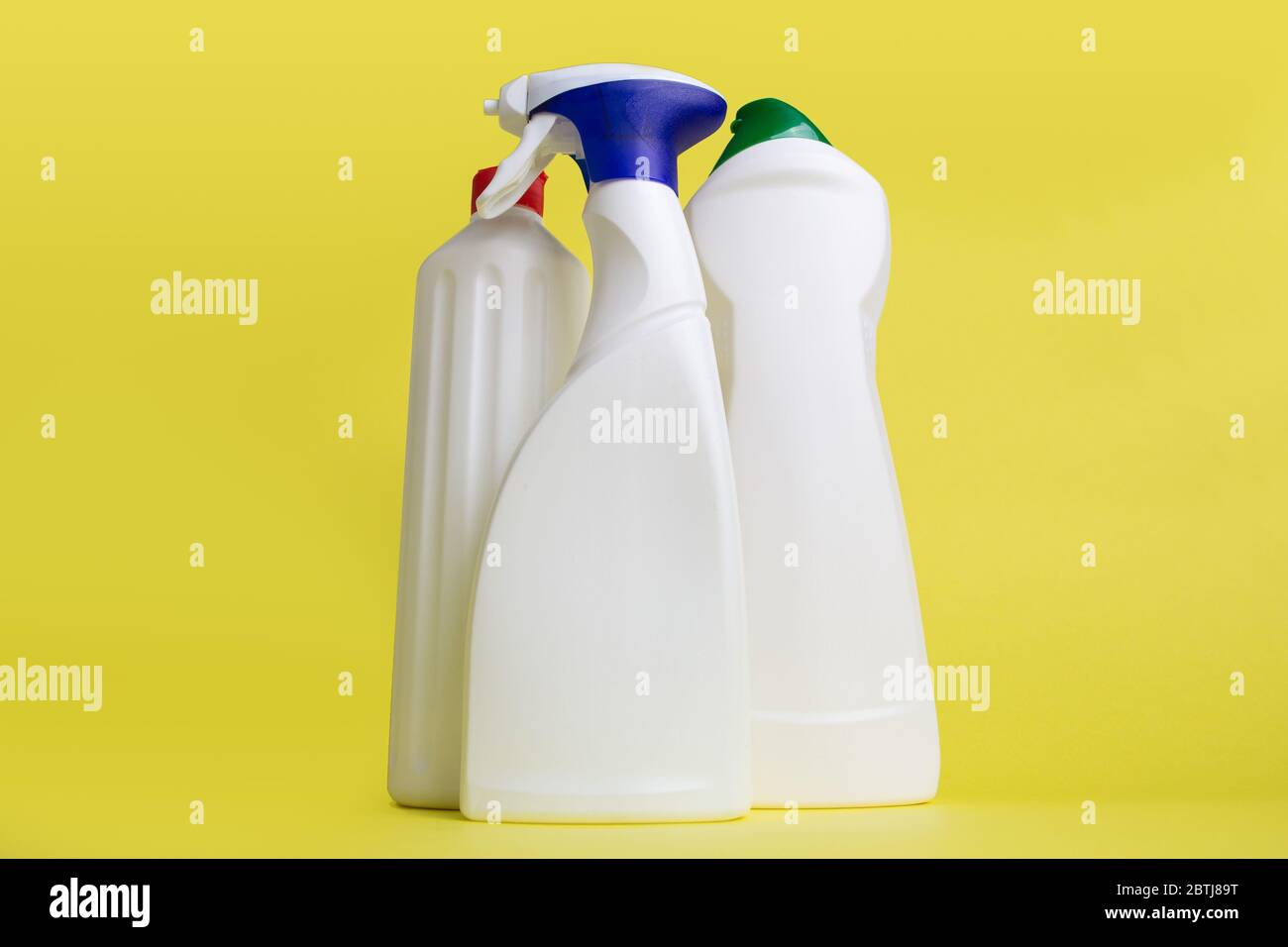 three cans of cleaning products on yellow background Stock Photo - Alamy