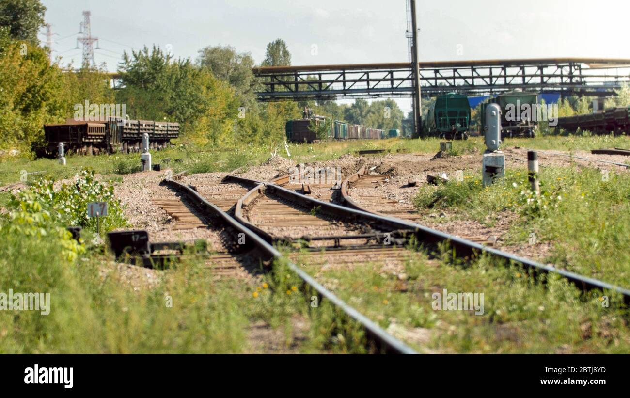 Toned image of old industrial railroad at the cargo hub with trains ...