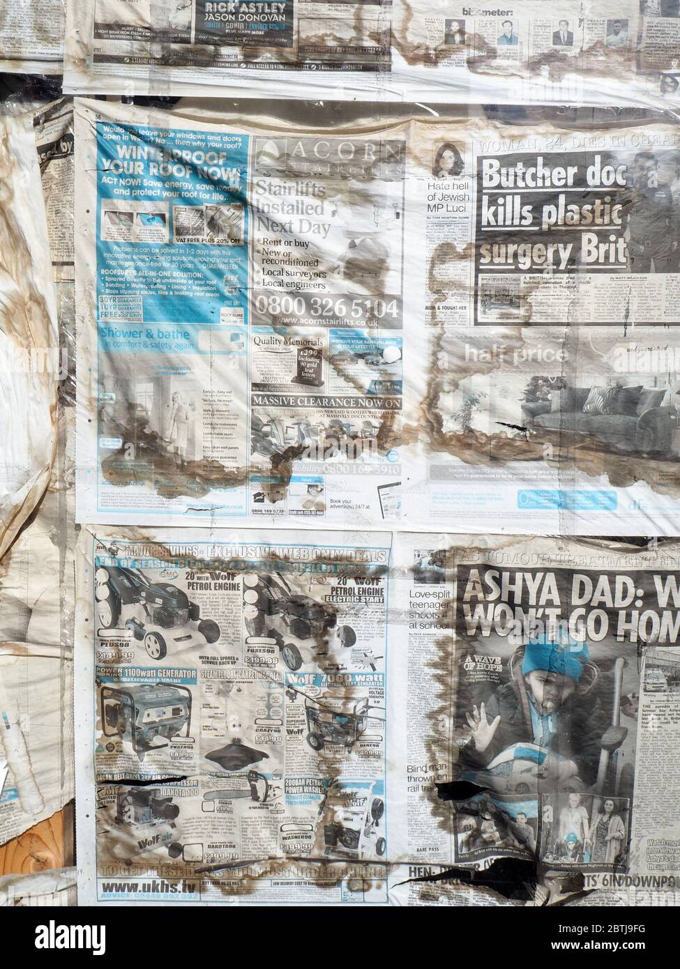 Window covered in newspapers Stock Photo - Alamy