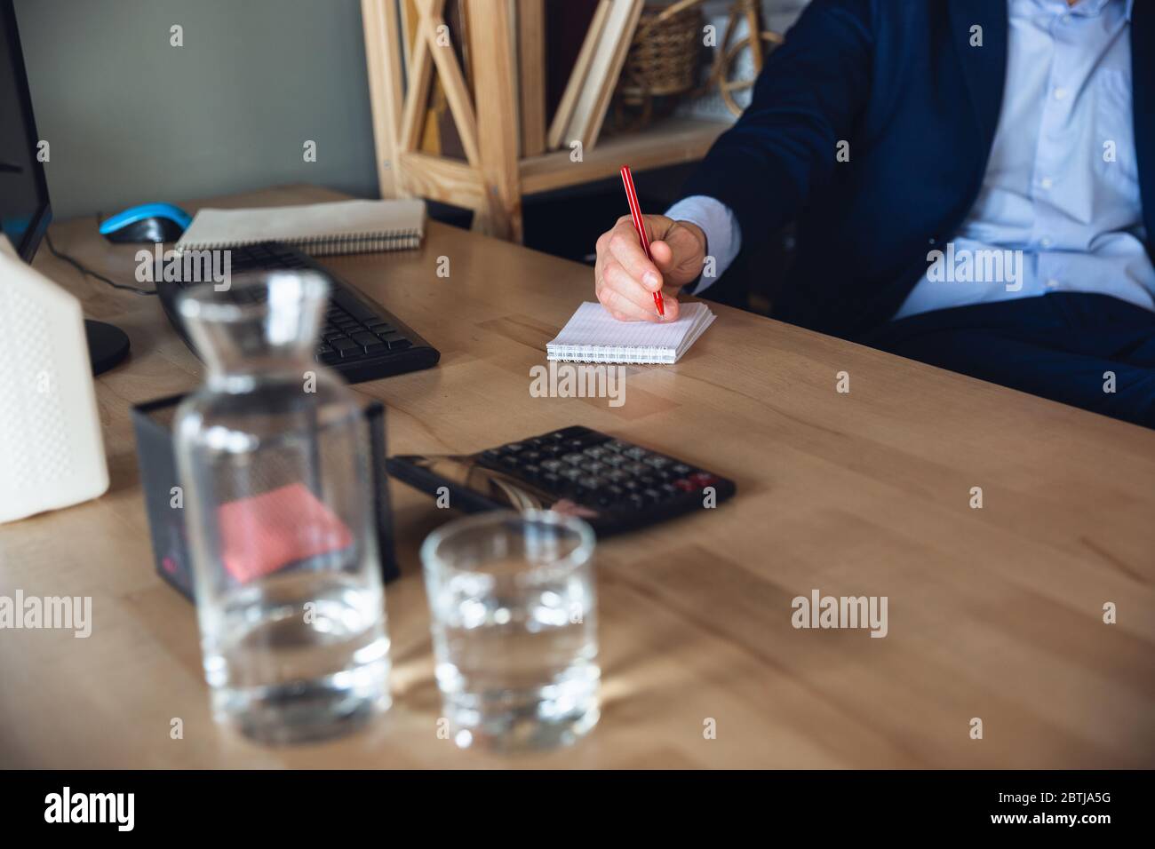 Talking on phone, taking notes. Close up young man, manager return to ...