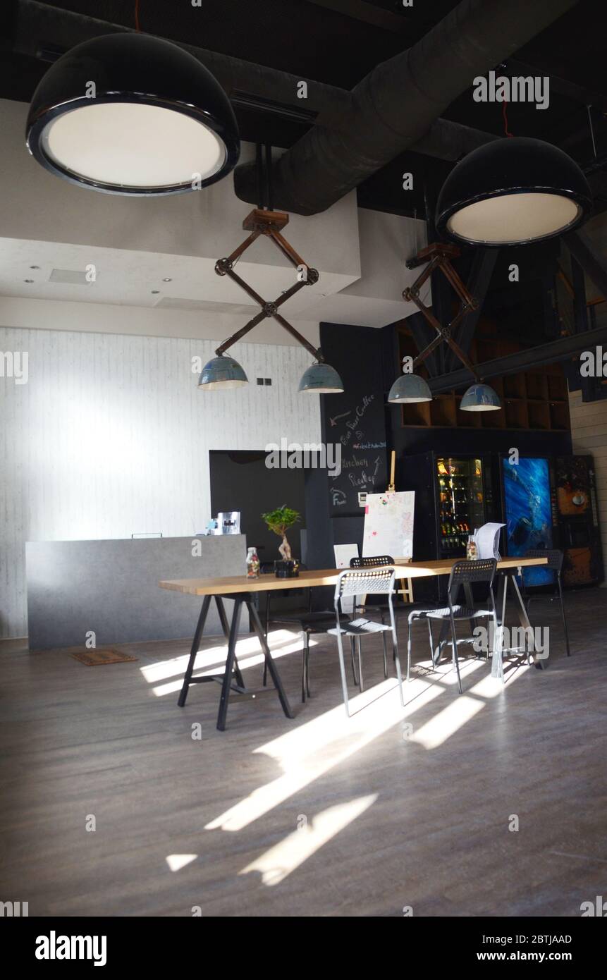 An industrial design style hostel lobby with warm sunlight Stock Photo ...
