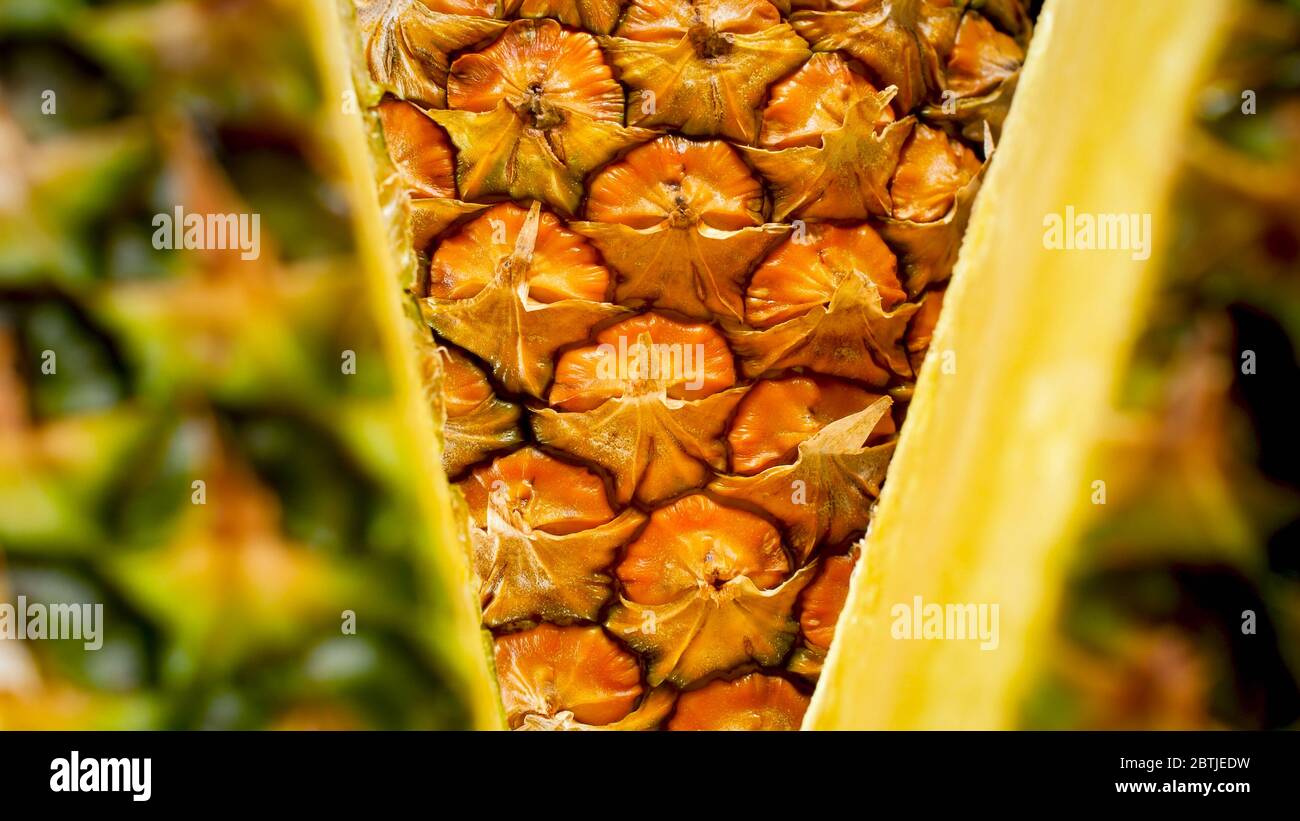 CLoseup abstract image of whole pineapple between two cut halves ...