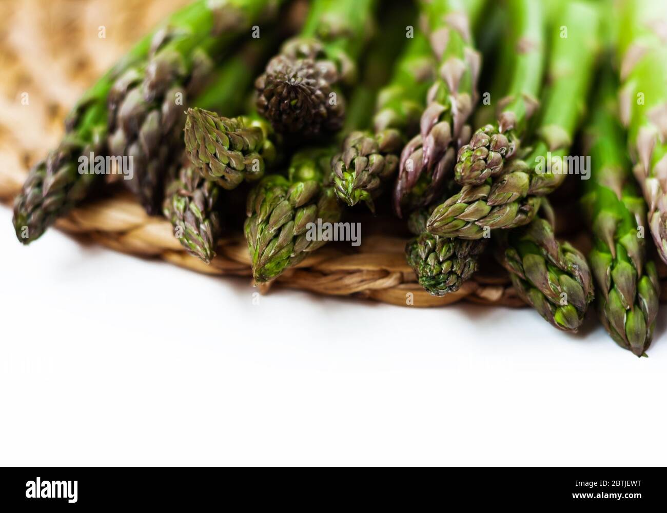 Bunch of fresh raw asparagus on white background, vegetarian concept ...