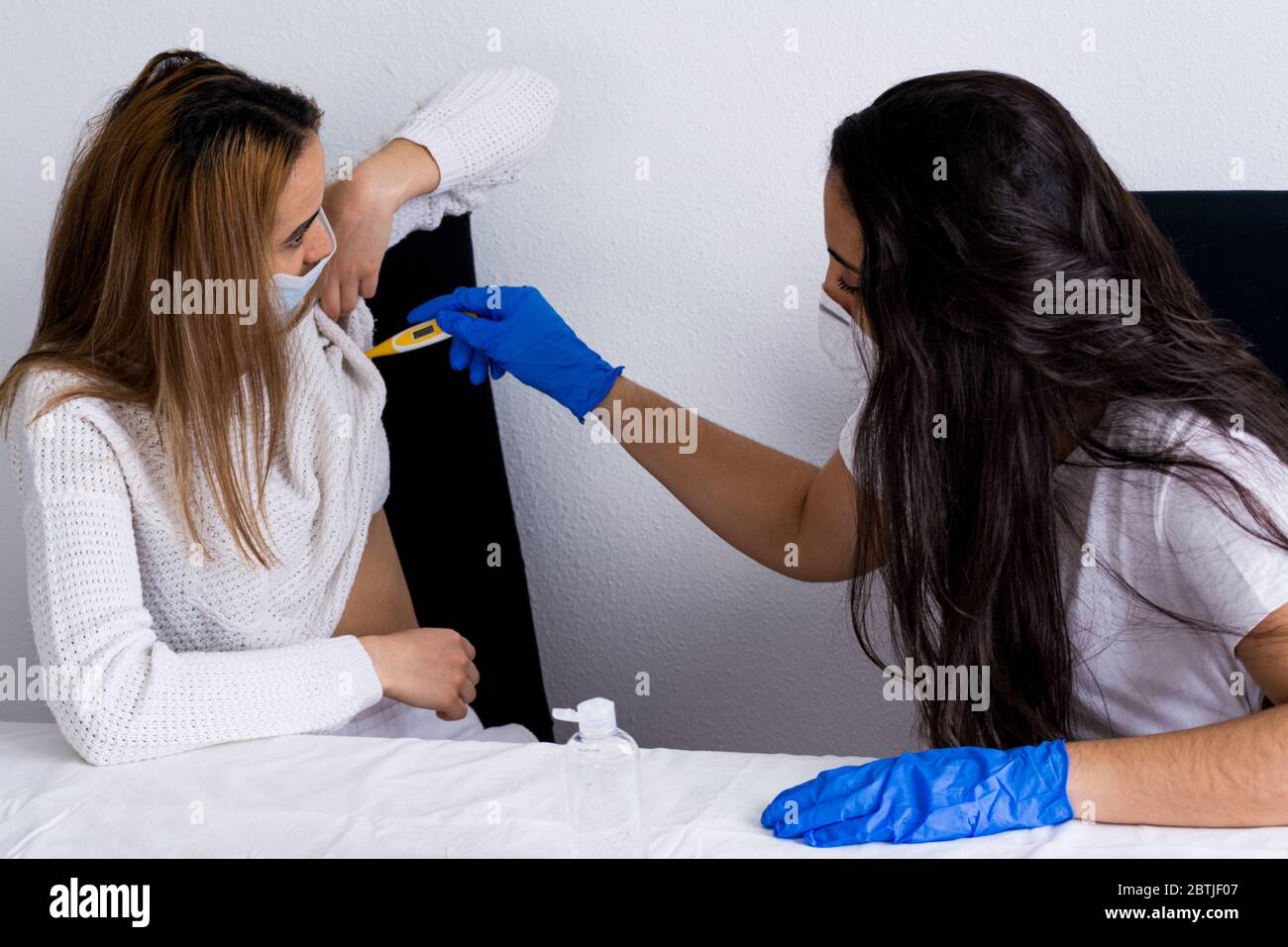 Nurse taking female patient temperature hi-res stock photography and ...
