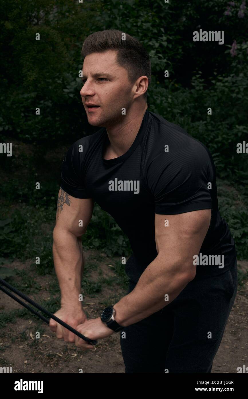 Athletic attractive guy is training outdoors. The concept of sports ...