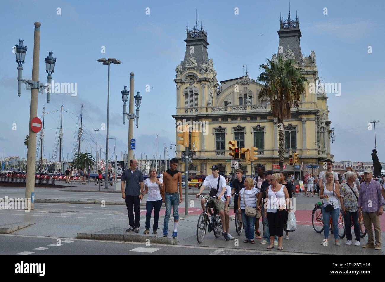 People waiting the red light to cross the road at Barcelona beach side ...