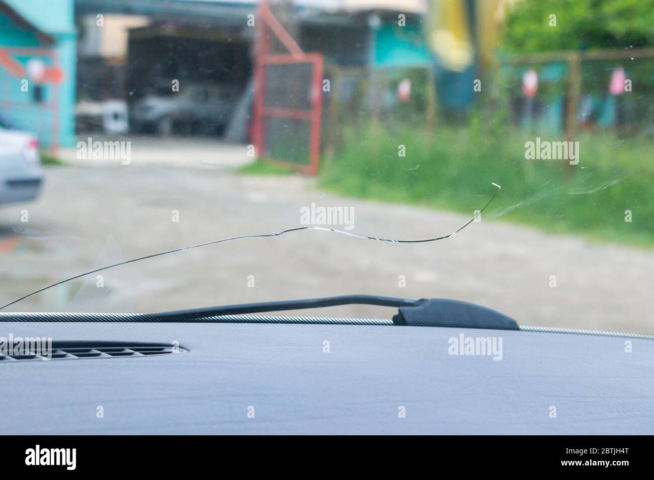 close-up photo of a cracked windscreen, view from inside of the car ...