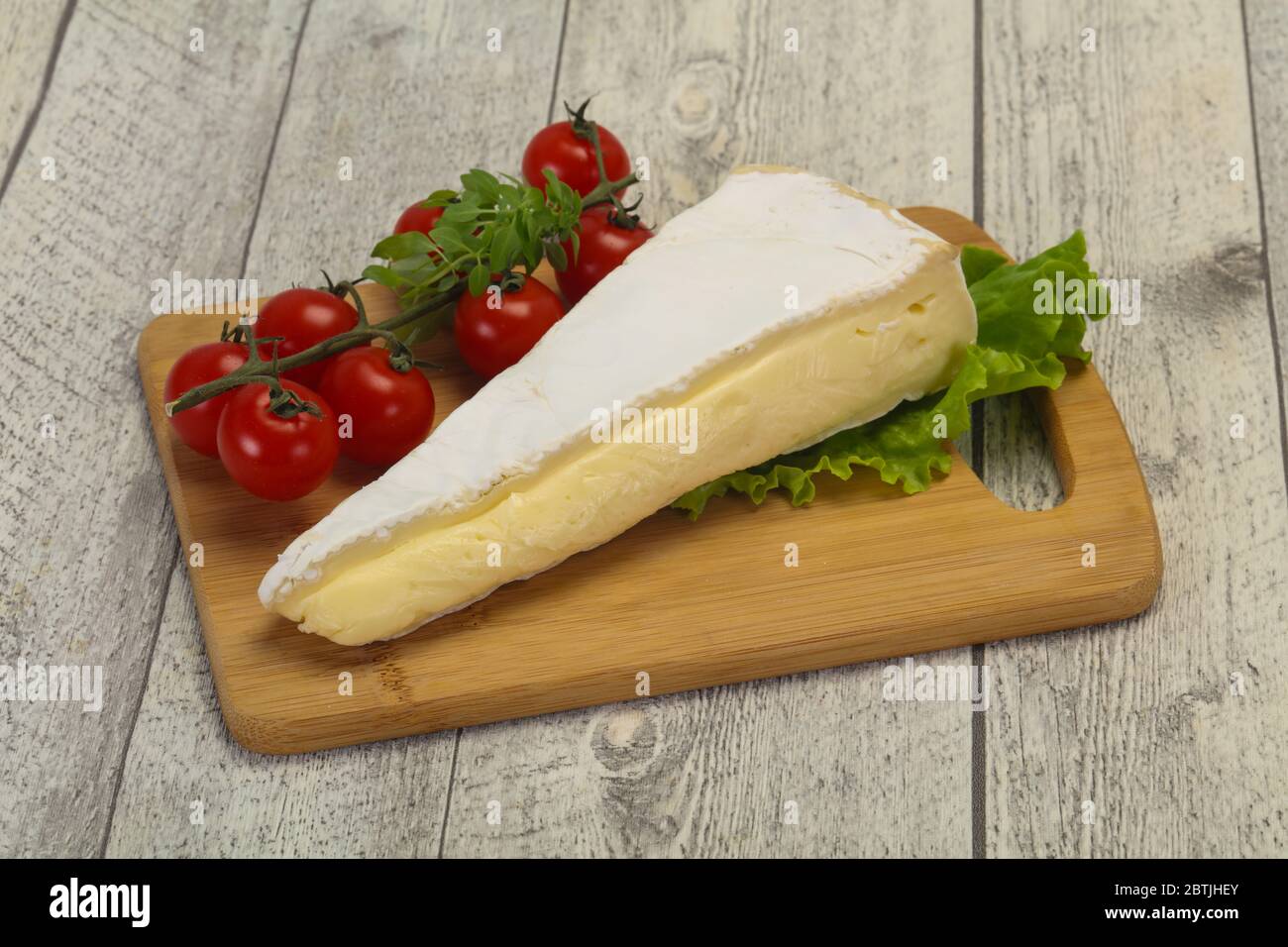 Brie cheese triangle served salad leaves Stock Photo - Alamy
