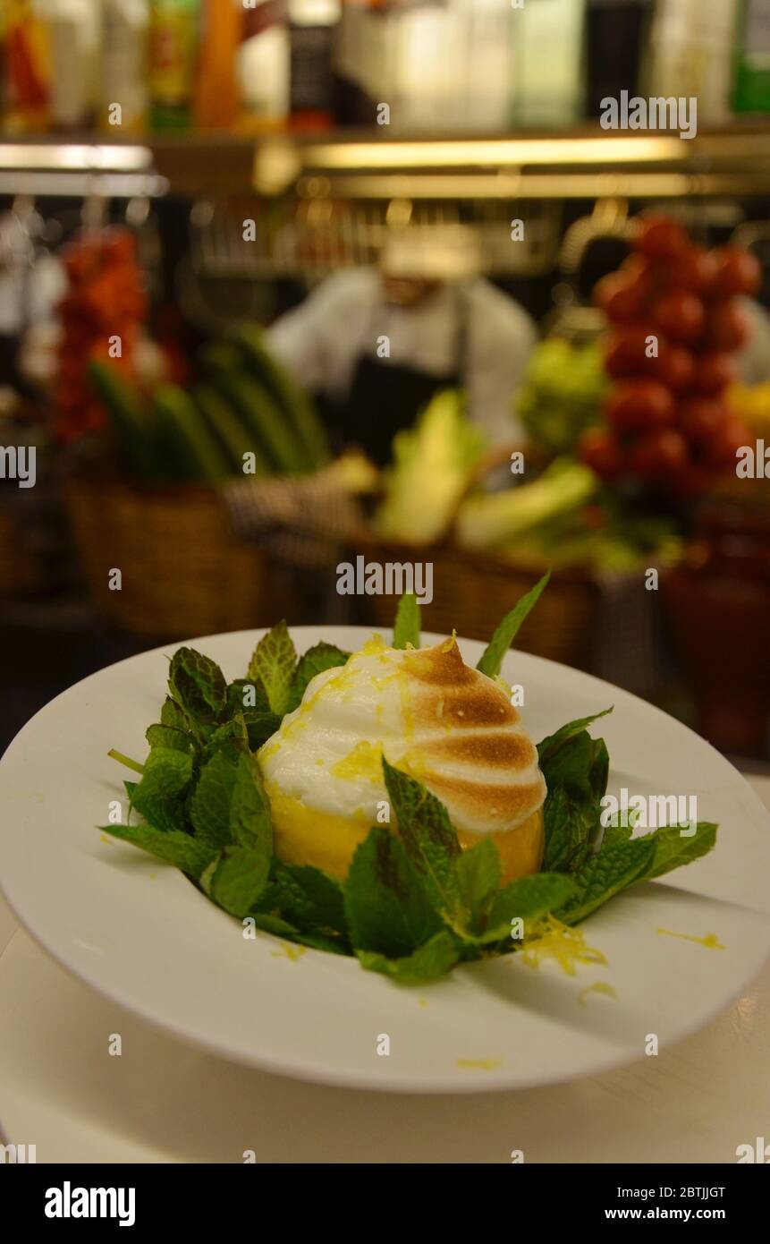 Zesty fire burned lemon meringue with peppermint Stock Photo - Alamy