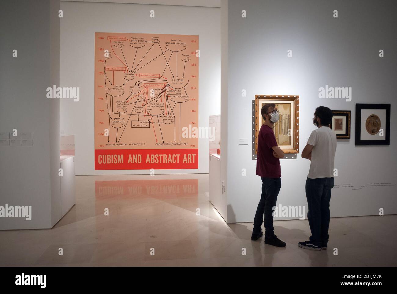 Visitors wearing face masks are seen at an exhibition of "Genealogies ...