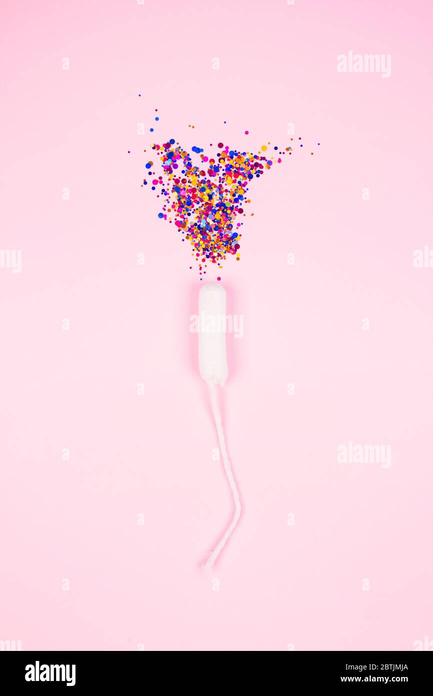 Clean cotton tampon with colorful sparkles on pastel pink background ...