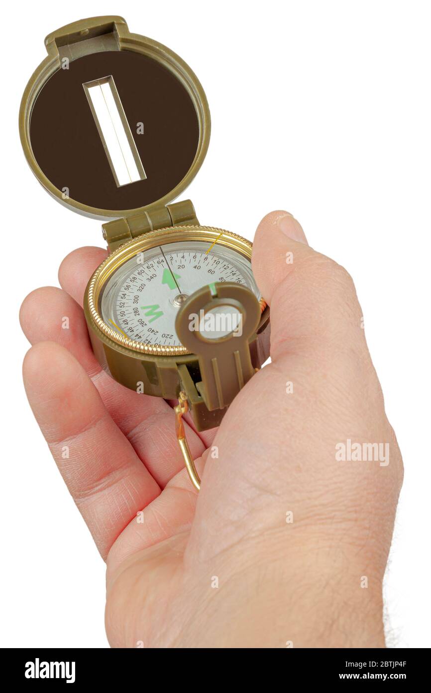 The hand holds a magnetic compass on a white background Stock Photo - Alamy
