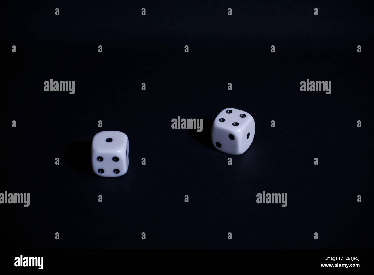 Two dice on black background, Static, horizontal Stock Photo - Alamy