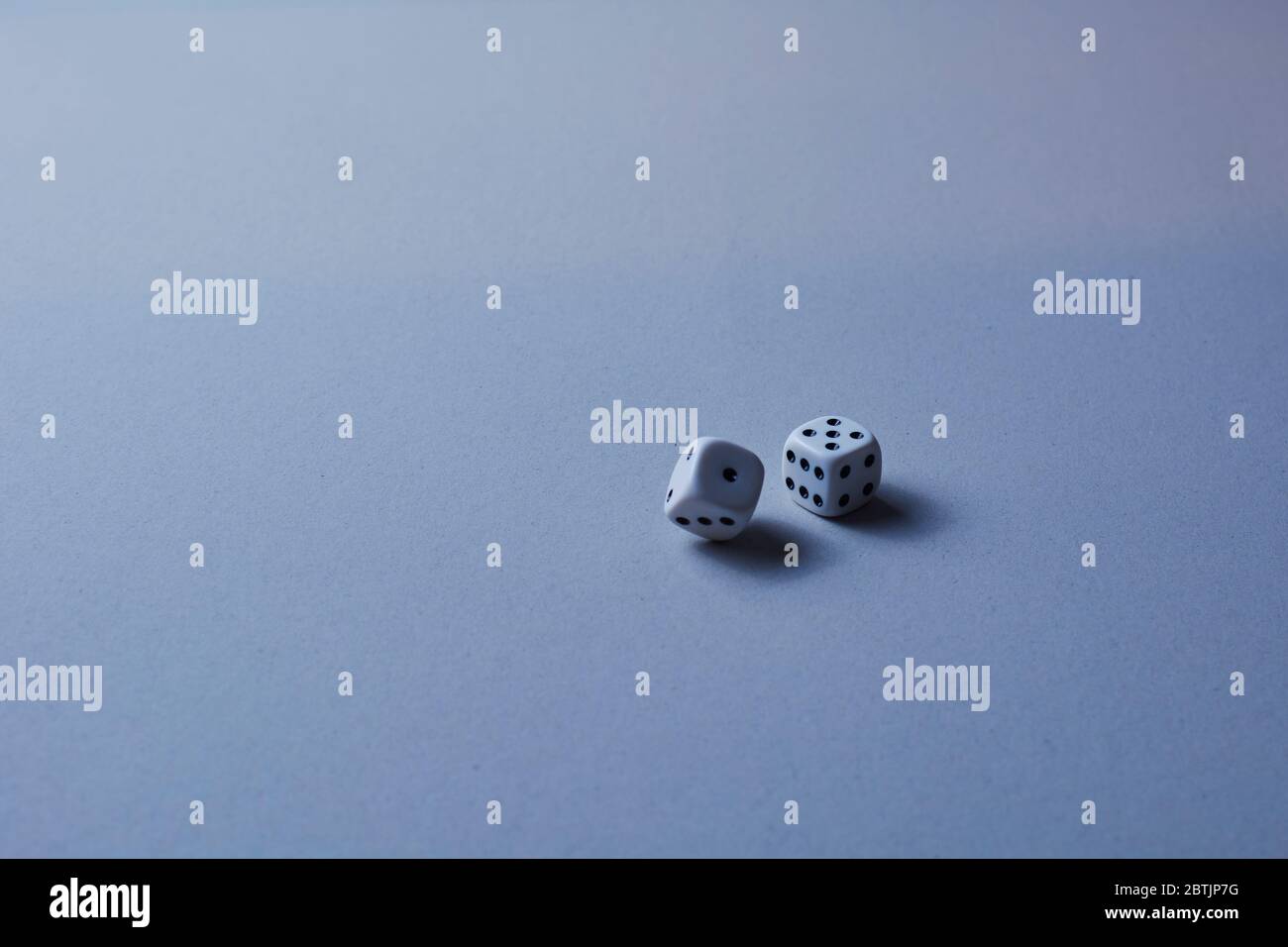 Two dice in motion, on white background, long exposure Stock Photo - Alamy