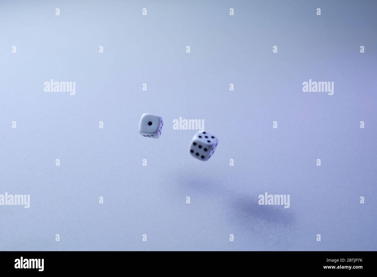 Two dice on white background flying, high speed, before hitting the ...