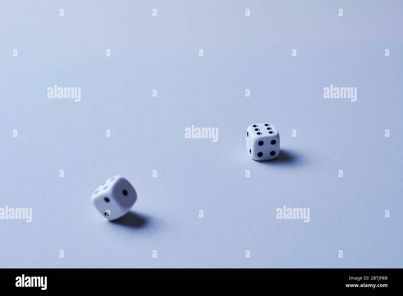 Two dice in motion, on white background, long exposure Stock Photo - Alamy