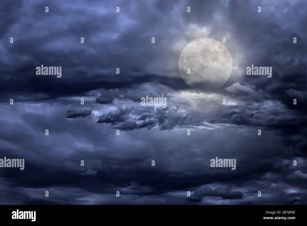 Beautiful full moon in an overcast night Stock Photo - Alamy