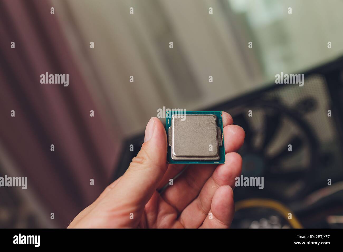 Macro view of modern multicore CPU processor in human hand with PC ...