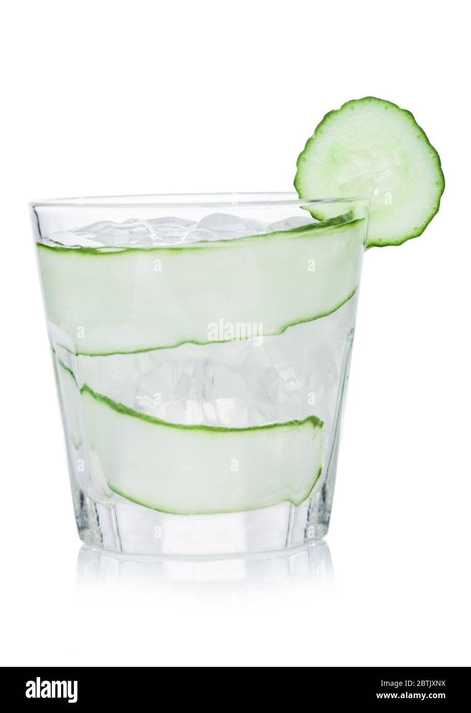 Fresh cold cucumber water with ice cubes and cucumber slices on white ...