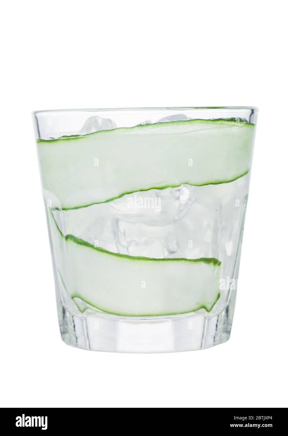 Fresh cold cucumber water with ice cubes and cucumber slices isolated ...