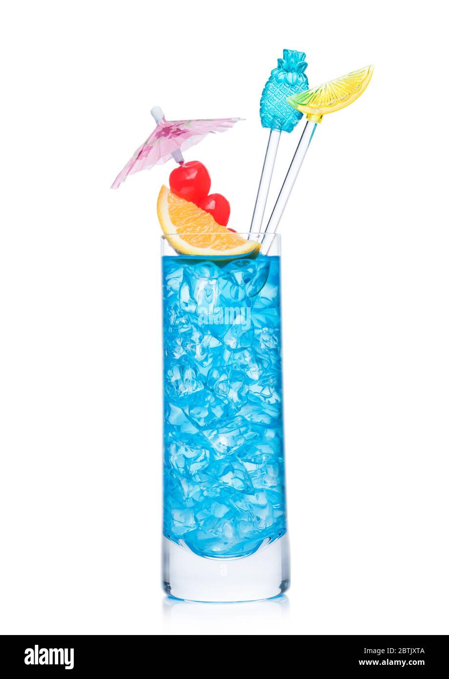 Blue lagoon cocktail highball glass with stirrers and orange slice with ...