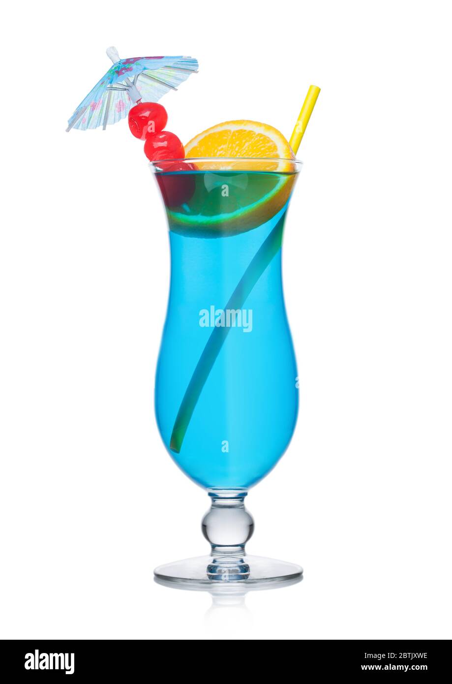 Blue lagoon cocktail classic glass with straw and orange slice with ...