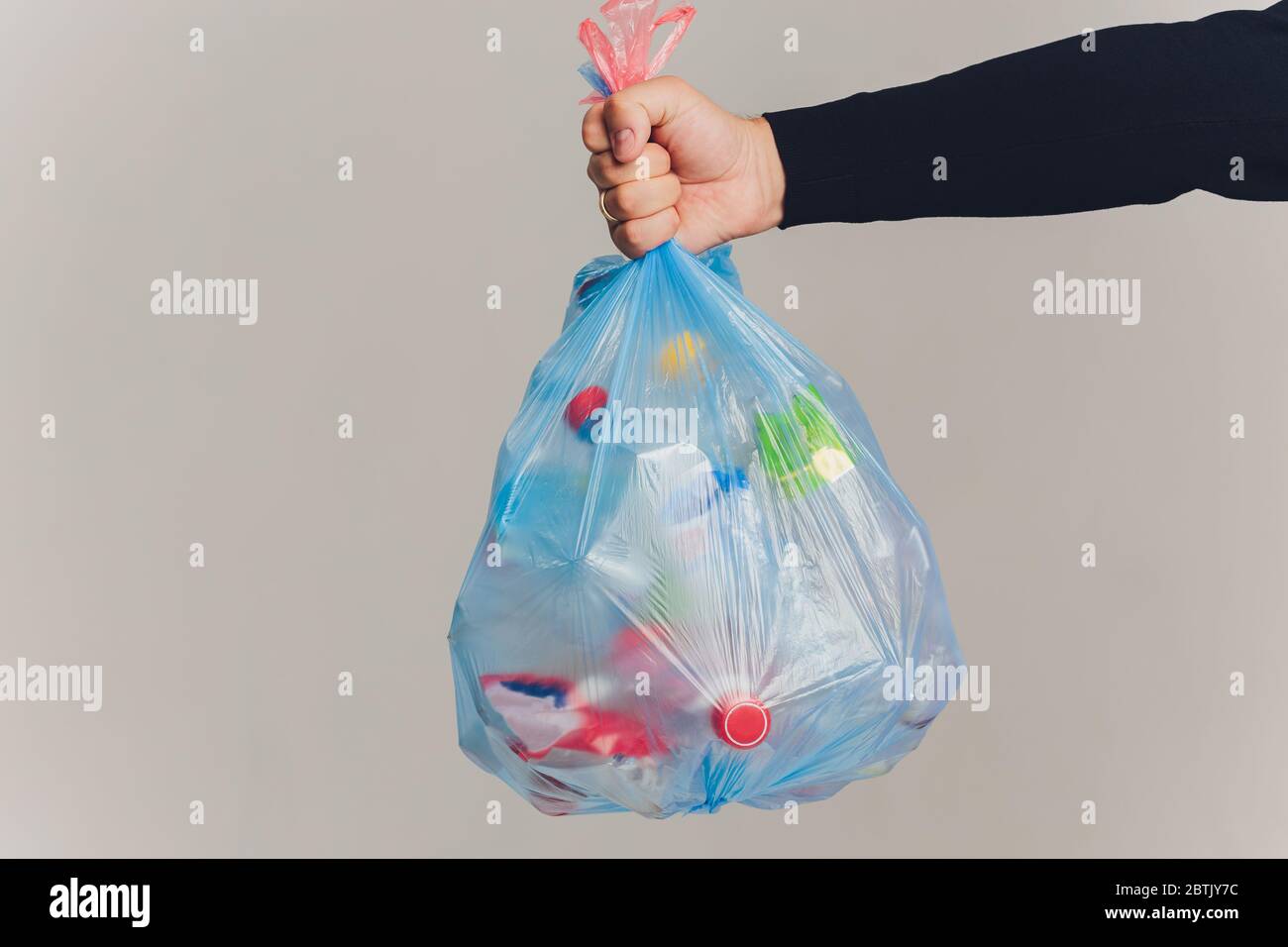 Man hands holding garbage bag isolated on white background Stock Photo ...