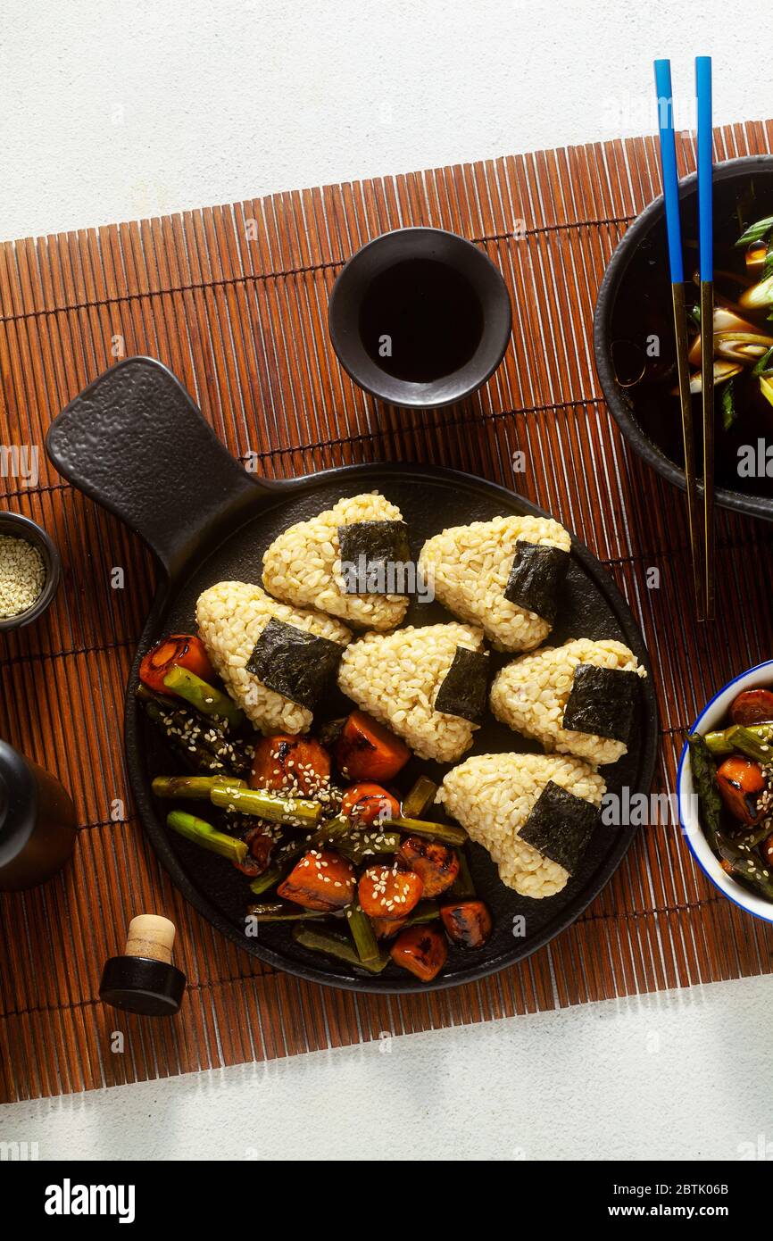 Japanese breakfast with miso soup, onigiri and vegetables in sweet and ...
