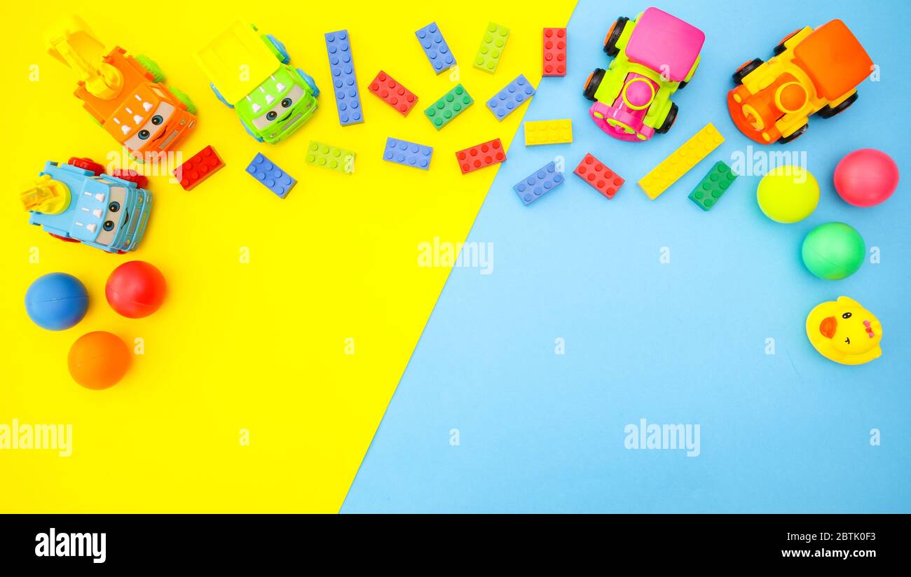 Colorful toys for kids on blue yellow background Stock Photo - Alamy