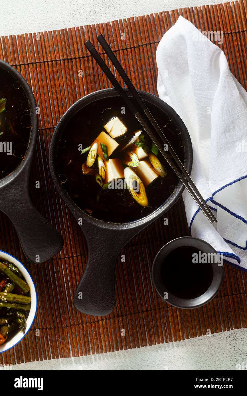 Japanese breakfast with miso soup, onigiri and vegetables in sweet and ...
