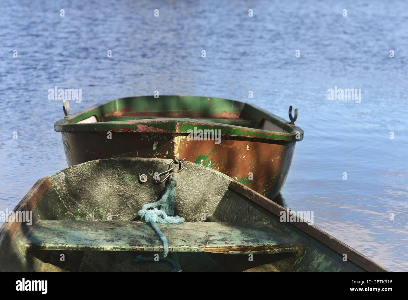 Two old row boats tied together Stock Photo - Alamy