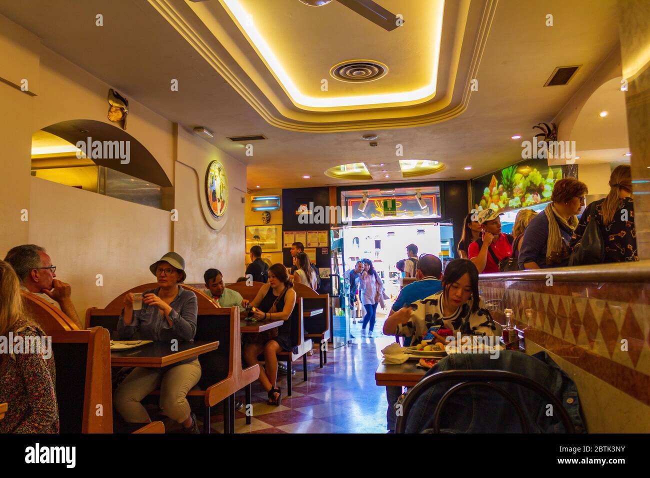 Traditional Italian cafeteria interior with tourists at the tables ...