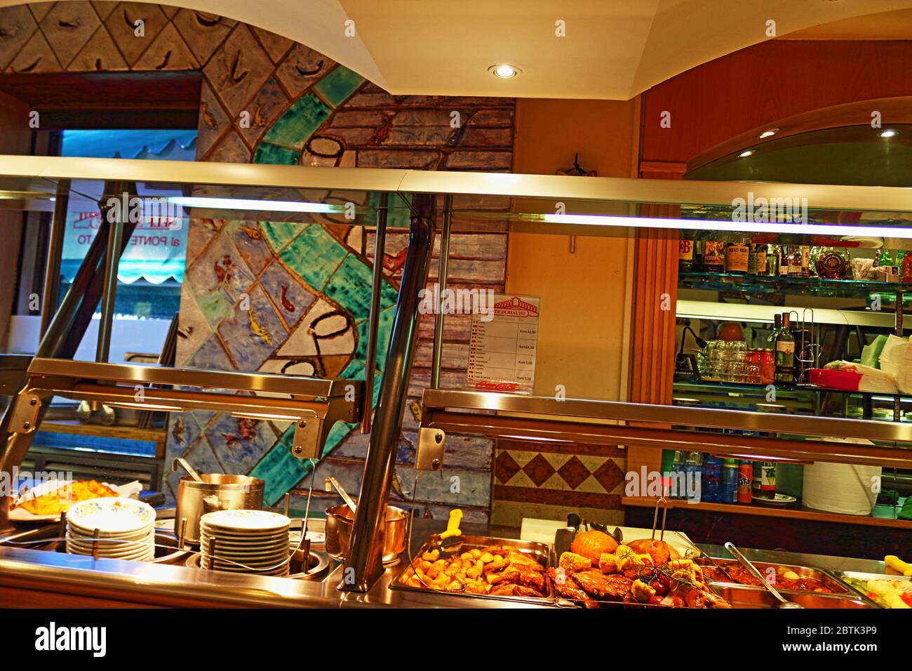 Traditional Italian cafeteria interior with tourists at the tables ...