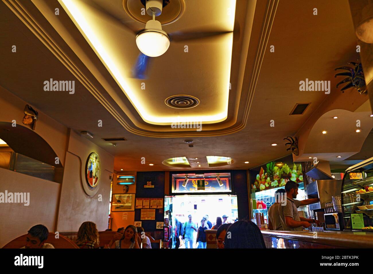Traditional Italian cafeteria interior with tourists at the tables ...