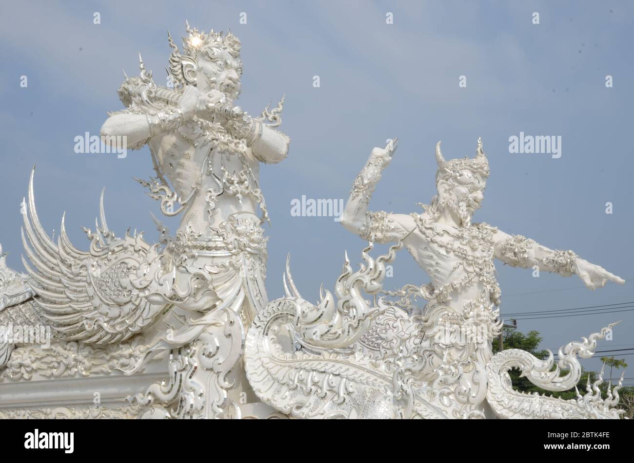 Two angry demons are guarding the entrance of Wat Rong Khun, the ...