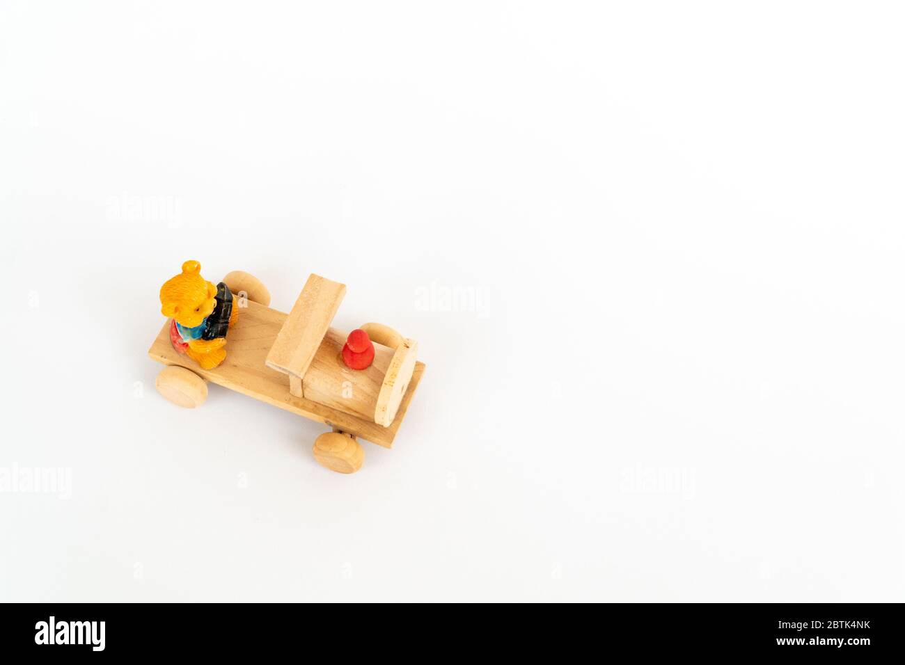 Wooden train on a white background. Wooden toy yellow locomotive with a ...