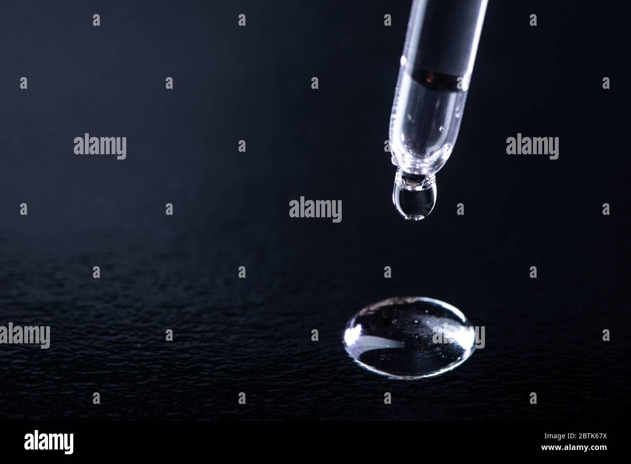 Close-up on a pipette with a drop of fluid Stock Photo - Alamy
