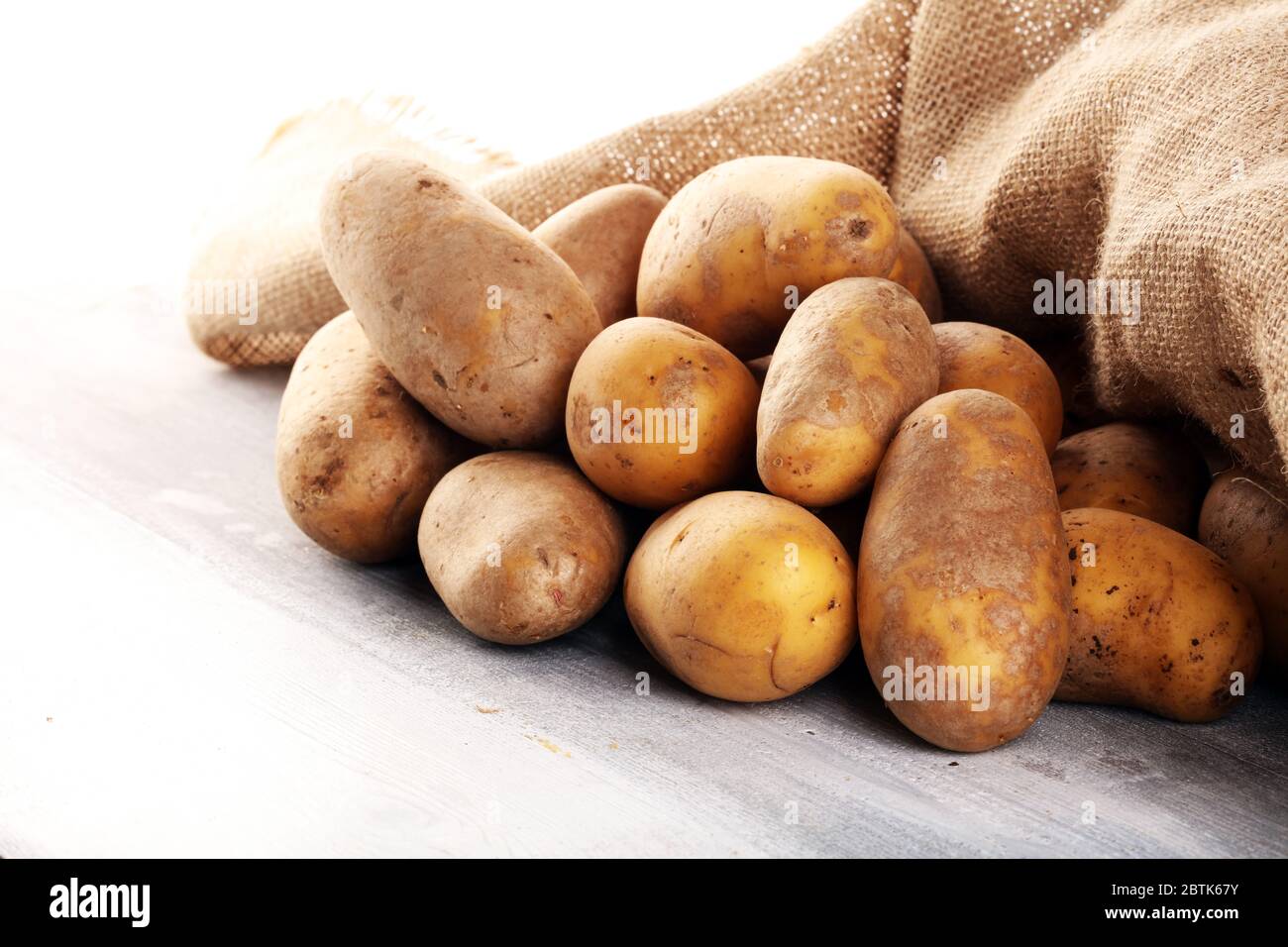 Pile of potatoes lying on wooden boards. Fresh potato on rustic ...