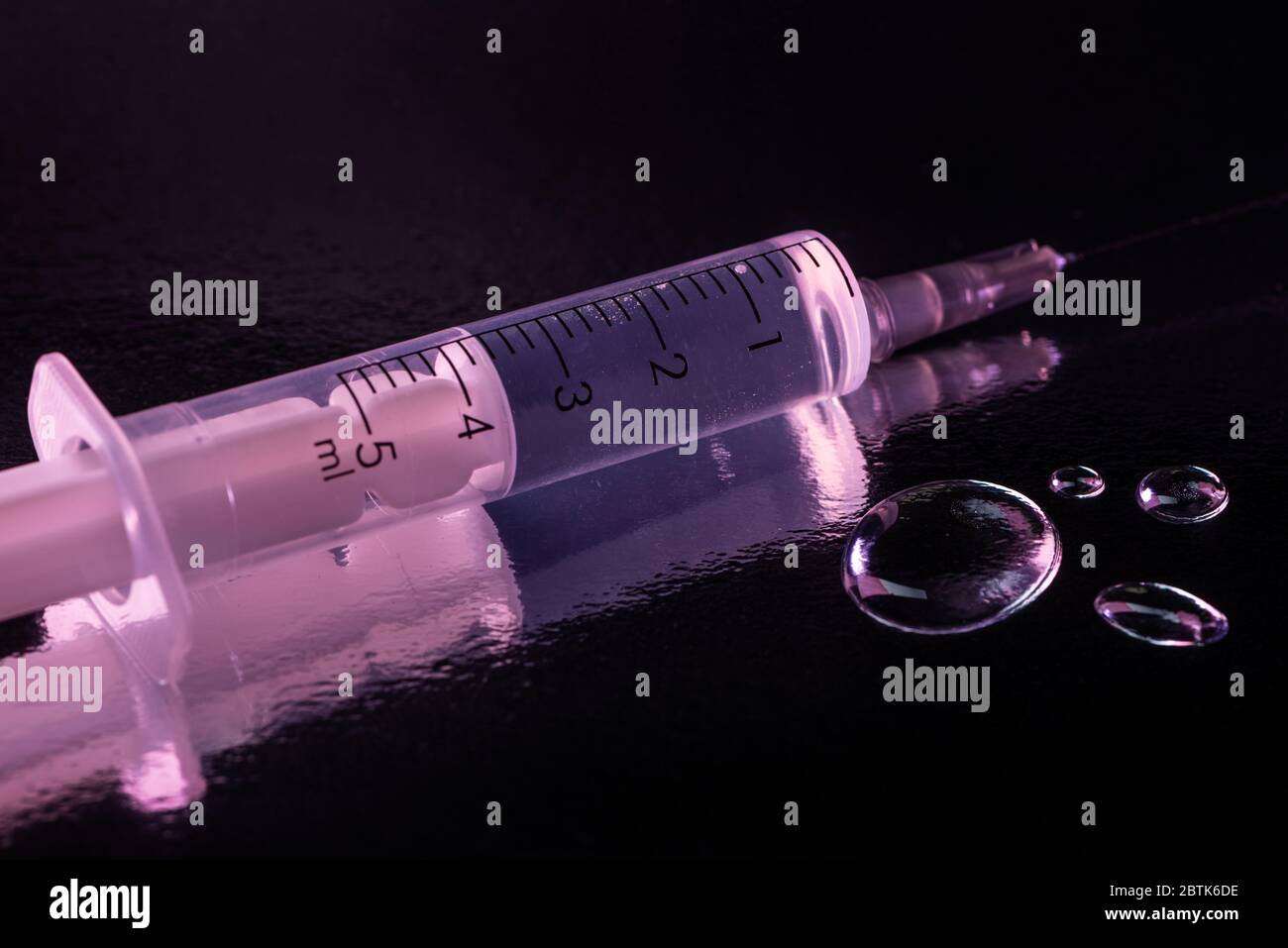 Close-up on a 5 ml syringe and few drops on dark background Stock Photo ...