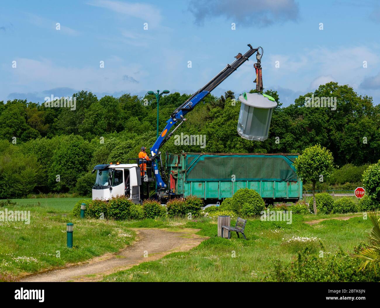 The garbage truck driver operator receives segregated waste from a ...