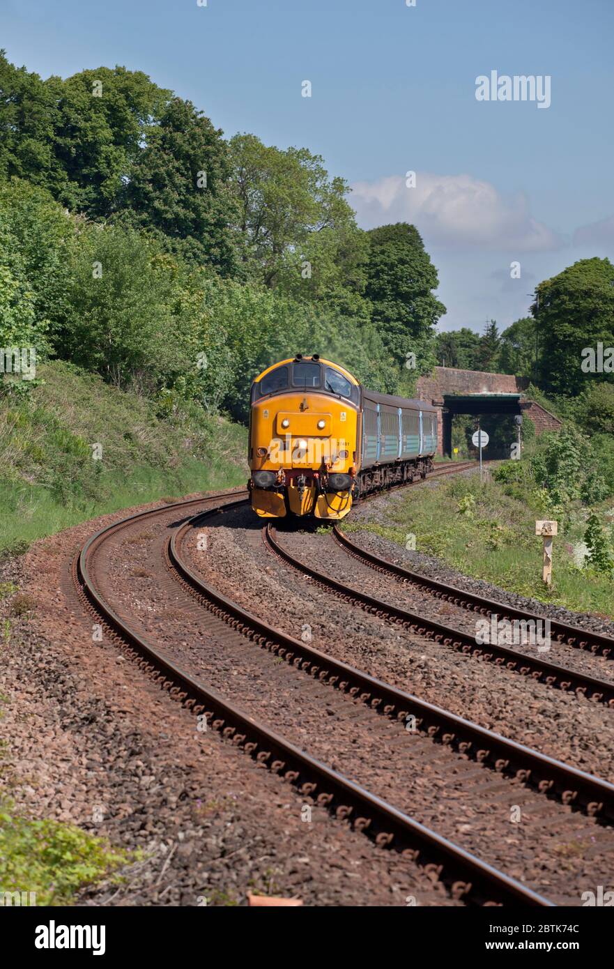 DRS Class 37 locomotive 37401 on the Cumbrian coast railway line with a ...
