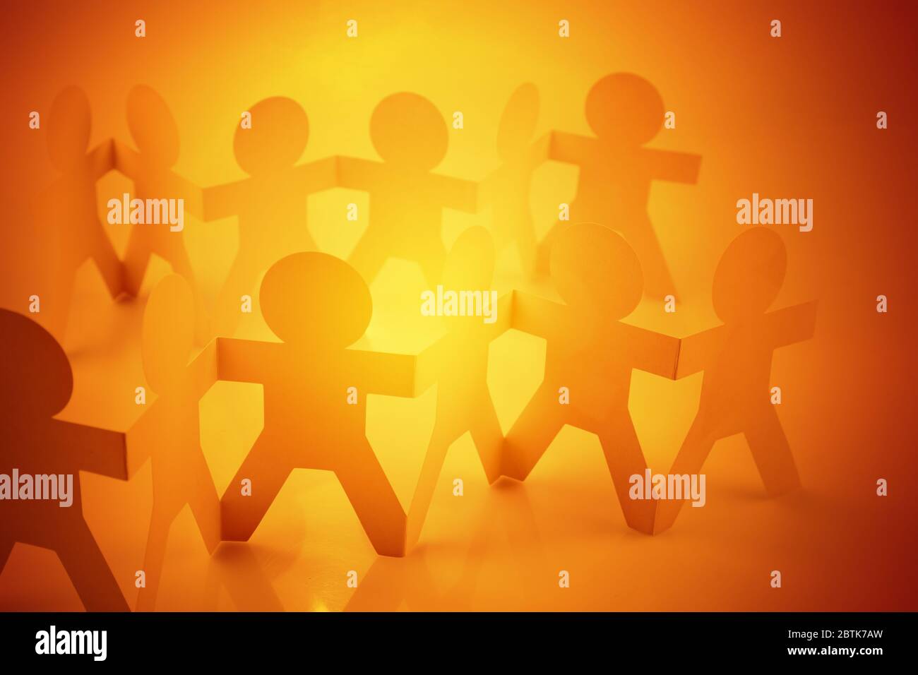 Paper chain team holding hands. Teamwork. Partnership Stock Photo - Alamy