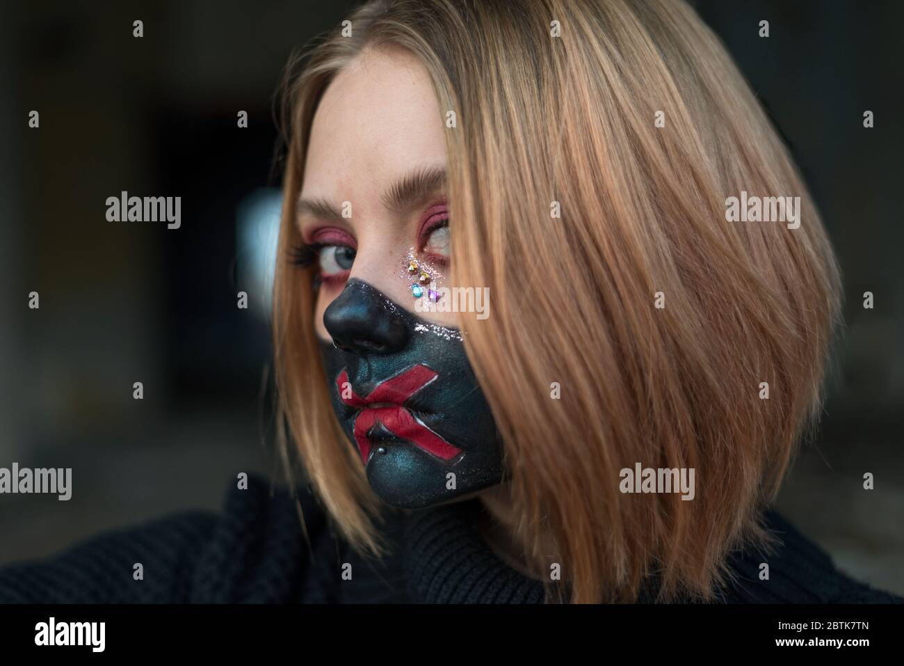 Closeup beauty portrait of a beautiful girl in a black mask with ...