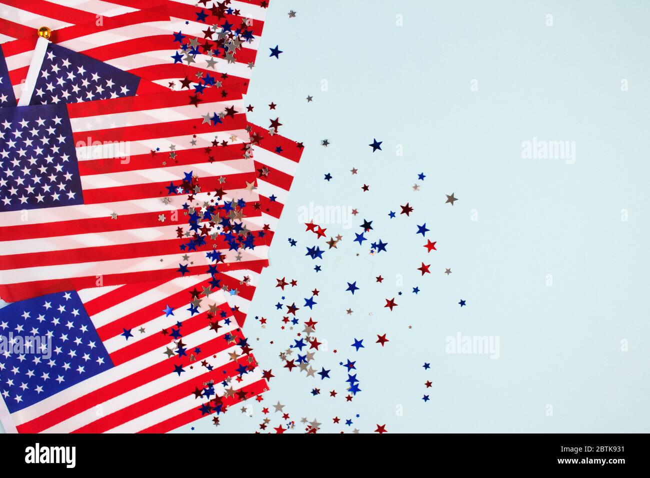 Flat lay composition with american flags and stars shaped sparkles on ...
