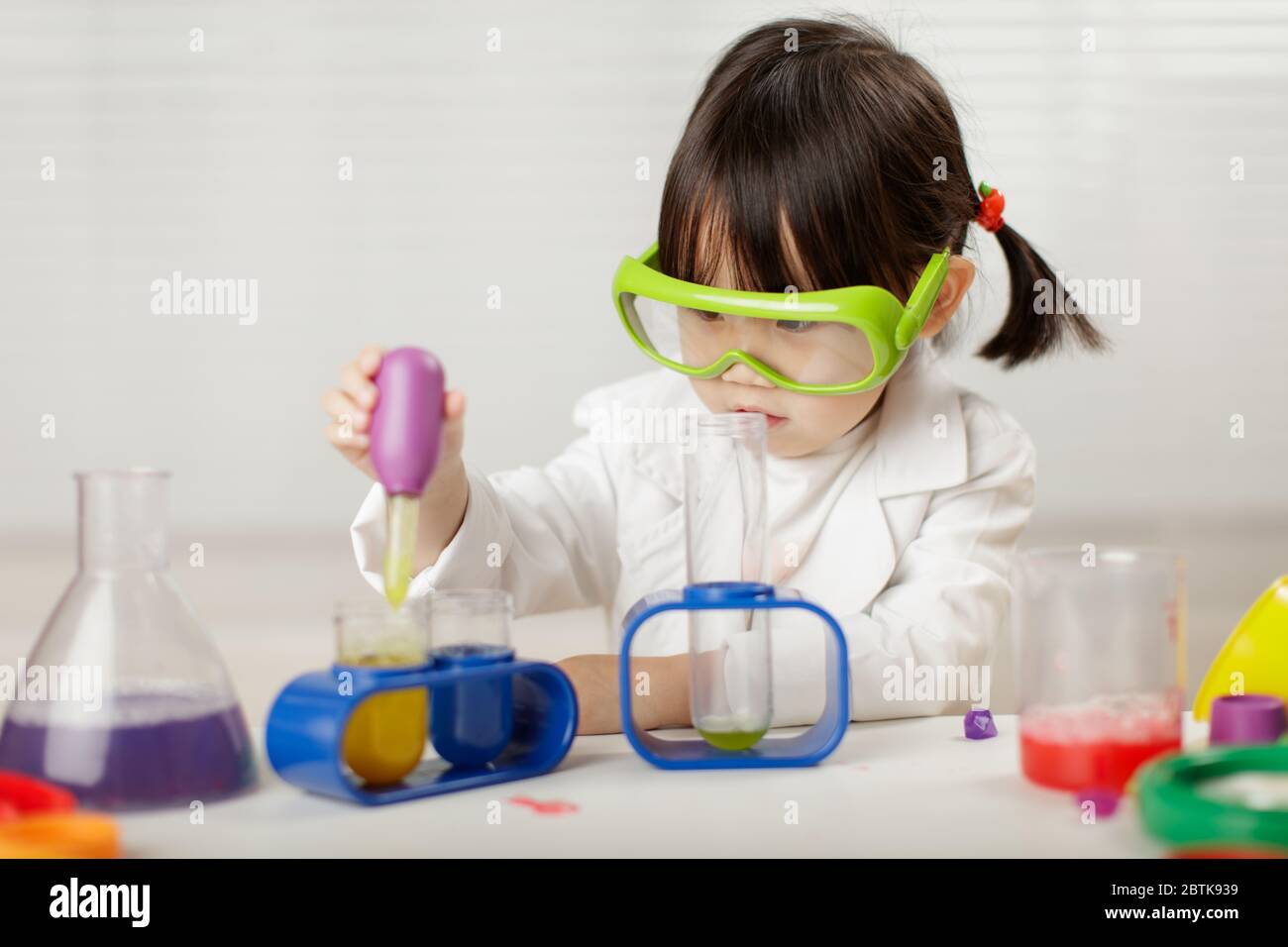 toddler girl pretend play scientist role for homeschooling Stock Photo ...